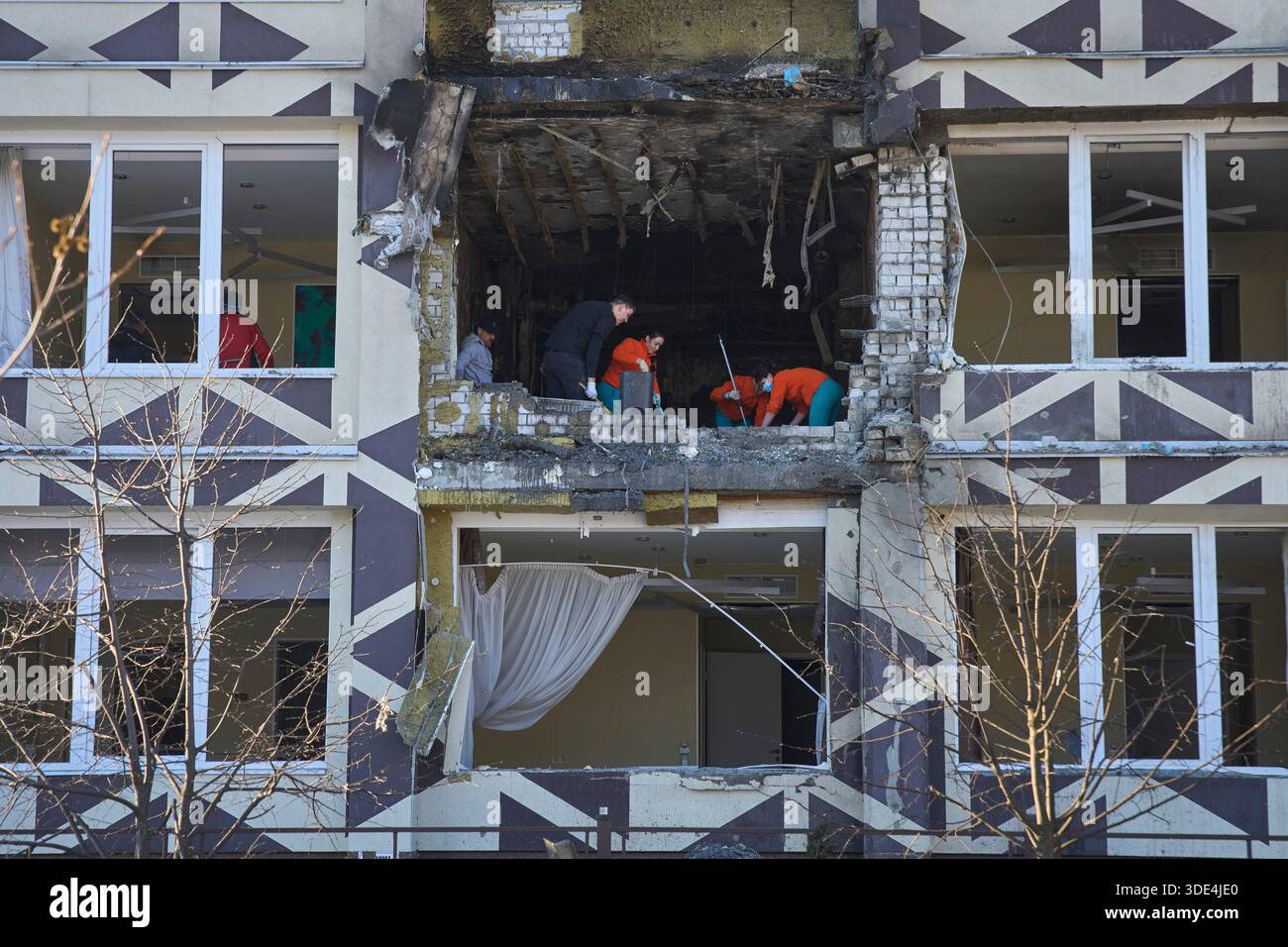 Medical workers remove the debris in a damaged private clinic after ...
