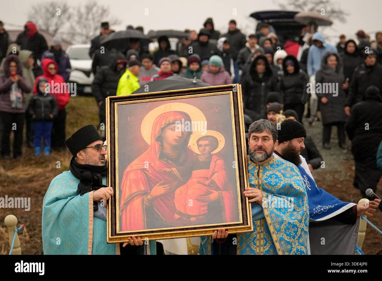Clerics carry an icon on a bank of the river Danube during a religious ...