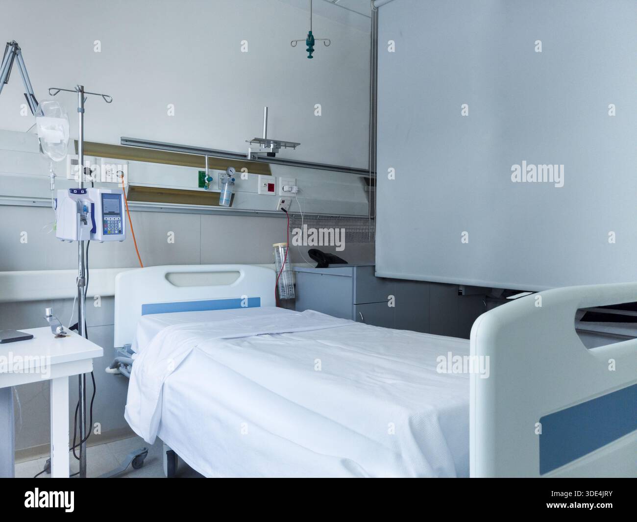 Hospital room with empty bed and medical gas, oxygen, and vacuum supply ...