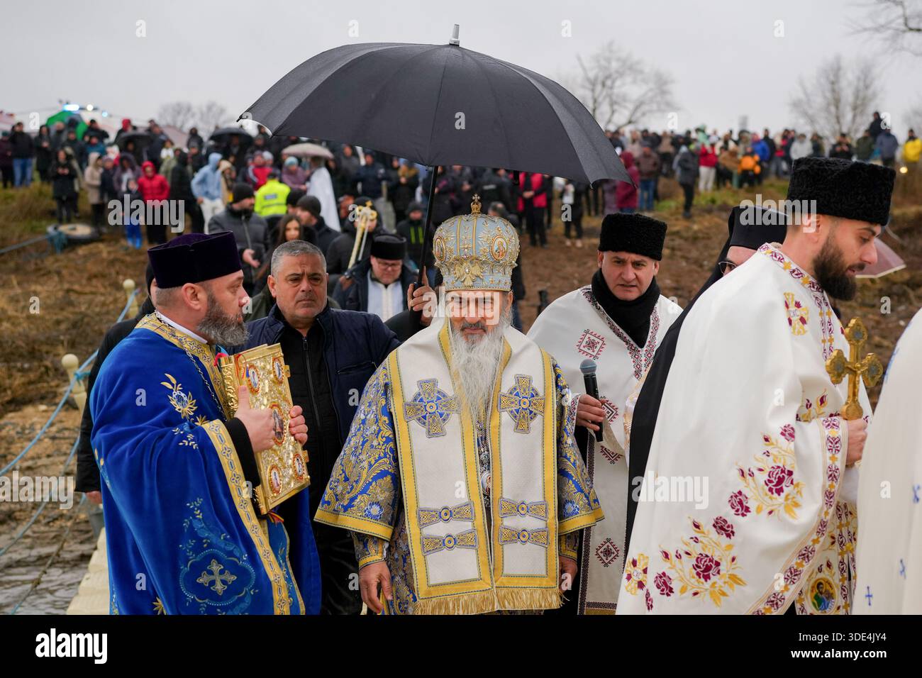 Orthodox archbishop Teodosie, centre, arrives on a bank of the river ...