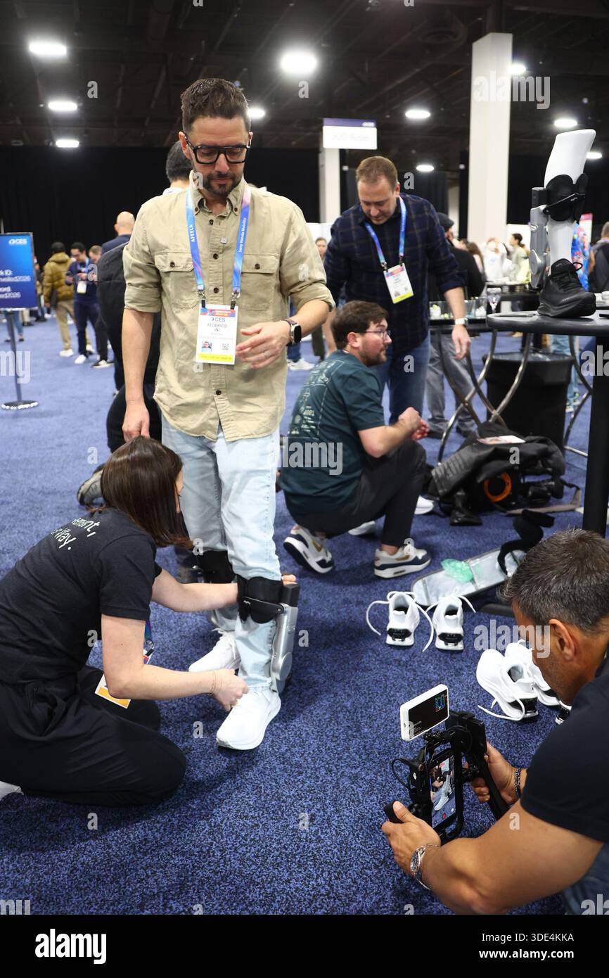 Members of the media are seen being outfitted with wearable bionic ...