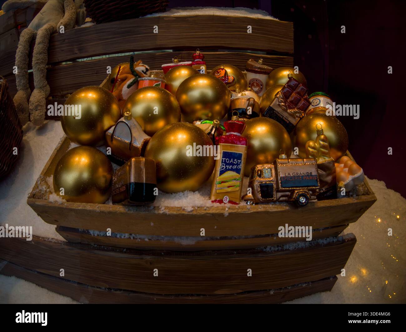 a box of gold baubles in Christmas window display at Le Bon Marché ...