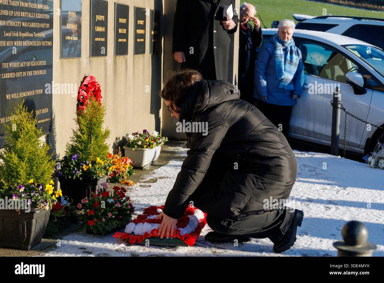 Kenzee Brush, granddaughter of Kenneth Worton, lays a wreath at an ...