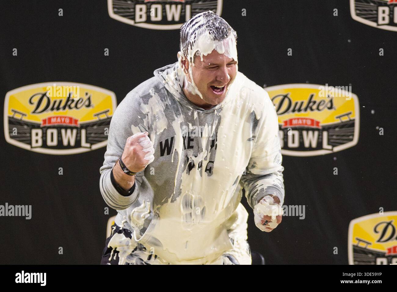 Wake Forest head coach Jake Dickert celebrates covered in mayonnaise ...