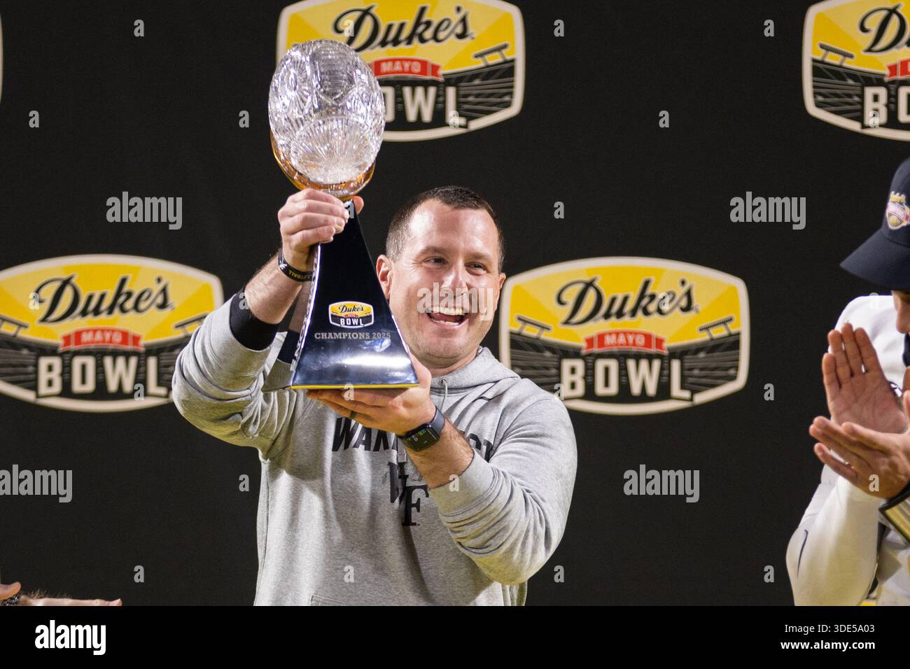 Wake Forest head coach Jake Dickert holds up the Duke's Mayo Bowl ...