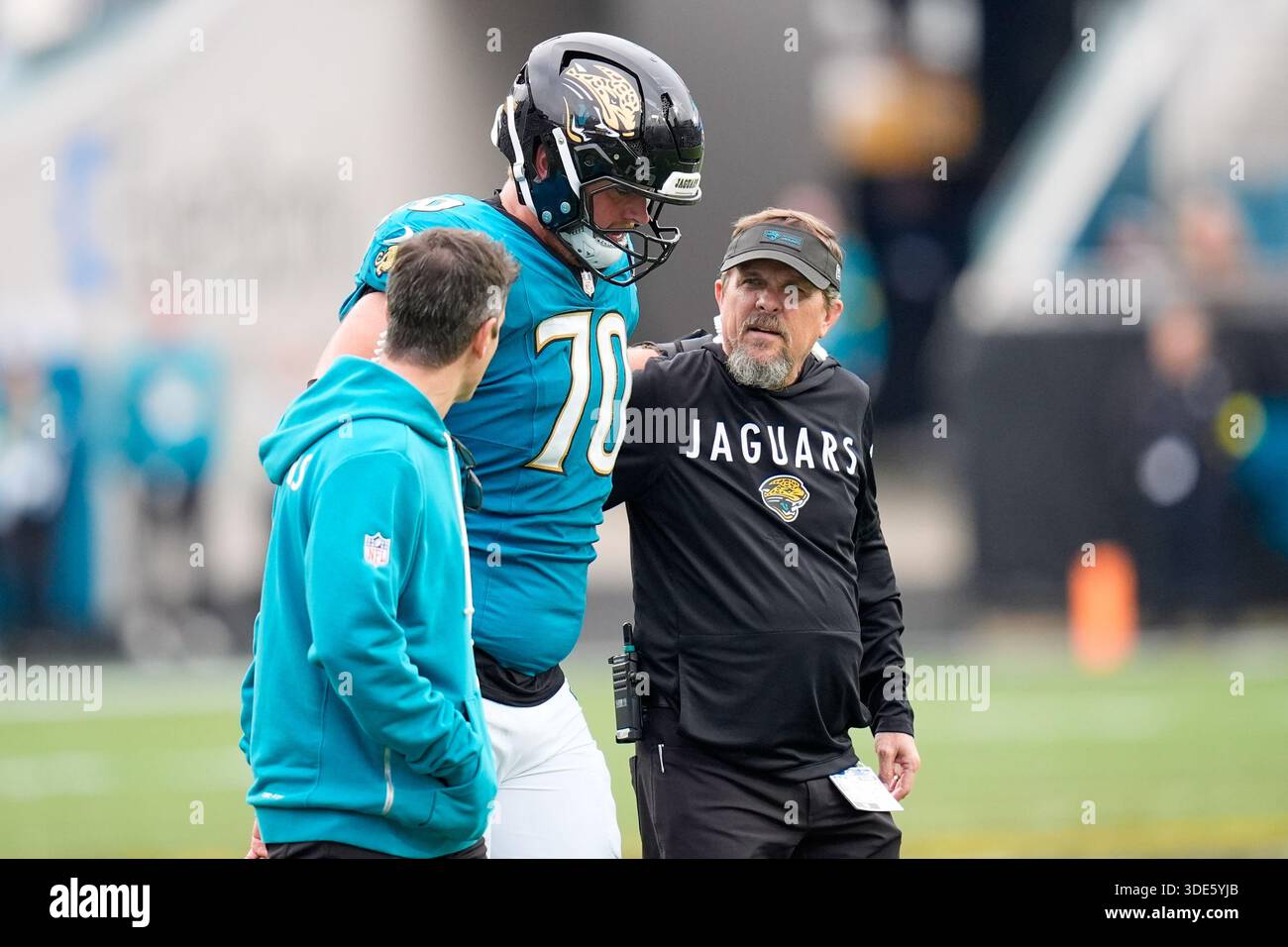 Jacksonville Jaguars offensive tackle Cole van Lanen (70) is helped off ...