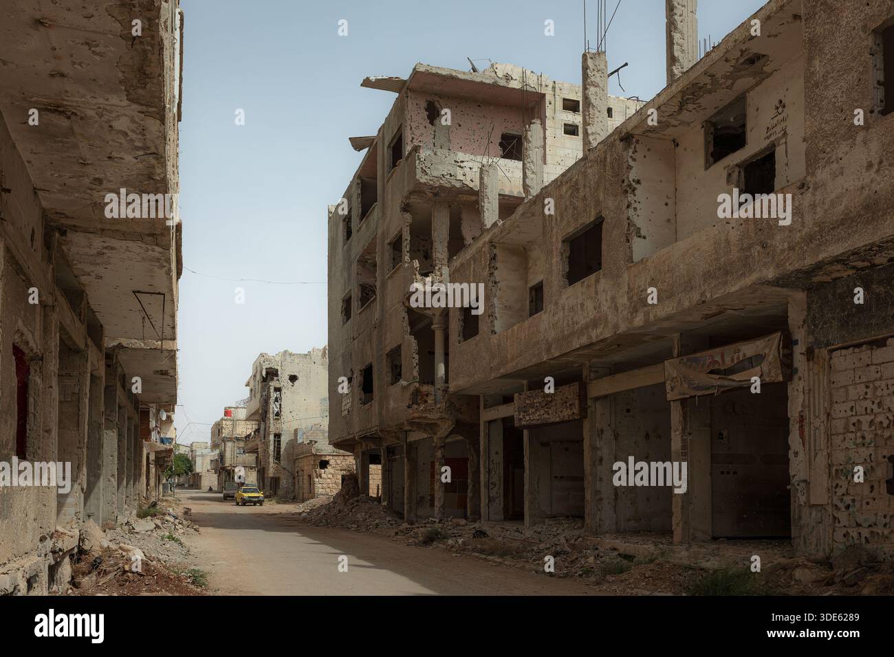 An empty war-damaged street in Daraa city. Devastating convergence of ...