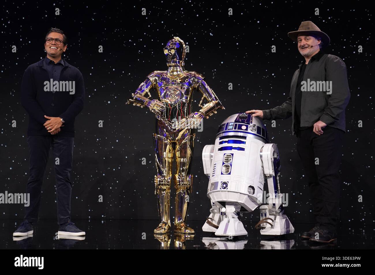 Asad Ayaz, left, and Dave Filioni stand on stage with C-3PO and R2-D2 ...