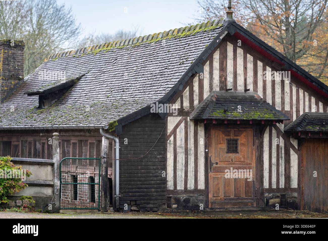 Traditional half-timbered Norman barn with weathered wooden door and ...