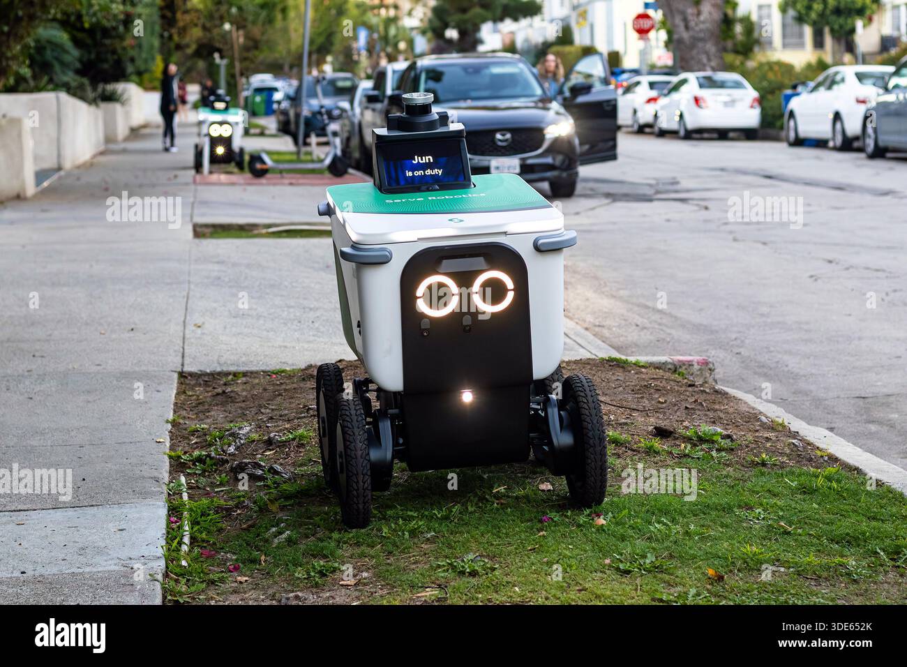 Delivery robot parked near the sidewalk, autonomous sidewalk delivery ...