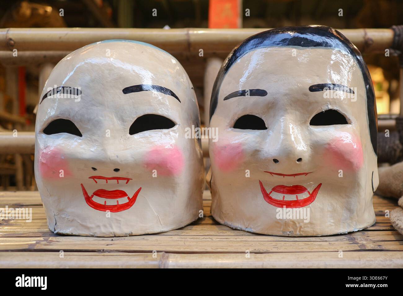 Two traditional Thai smiling masks with joyful expressions displayed on ...