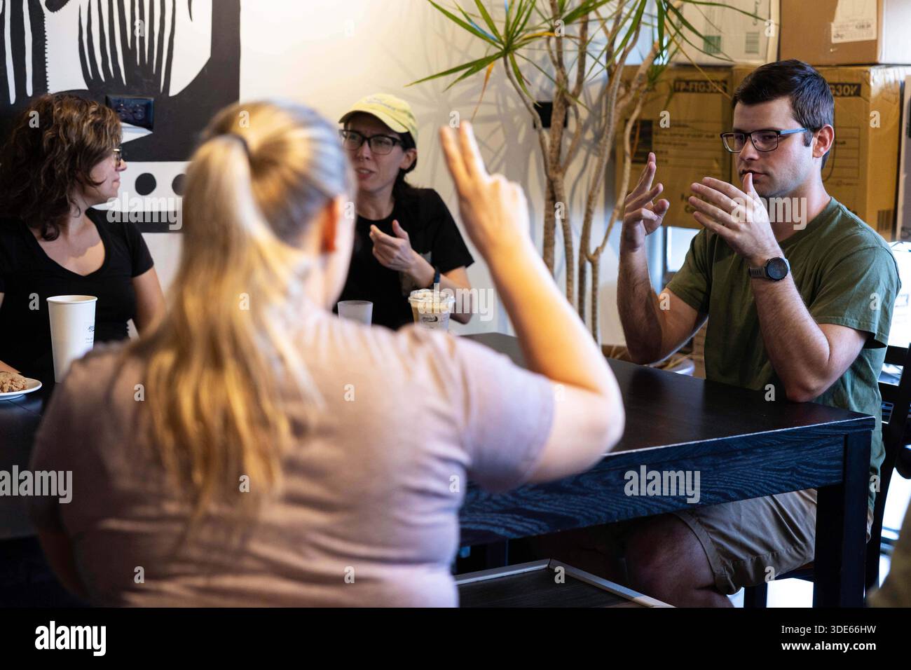 People attending a weekly meet up called "Sign Squad" communicate in ...