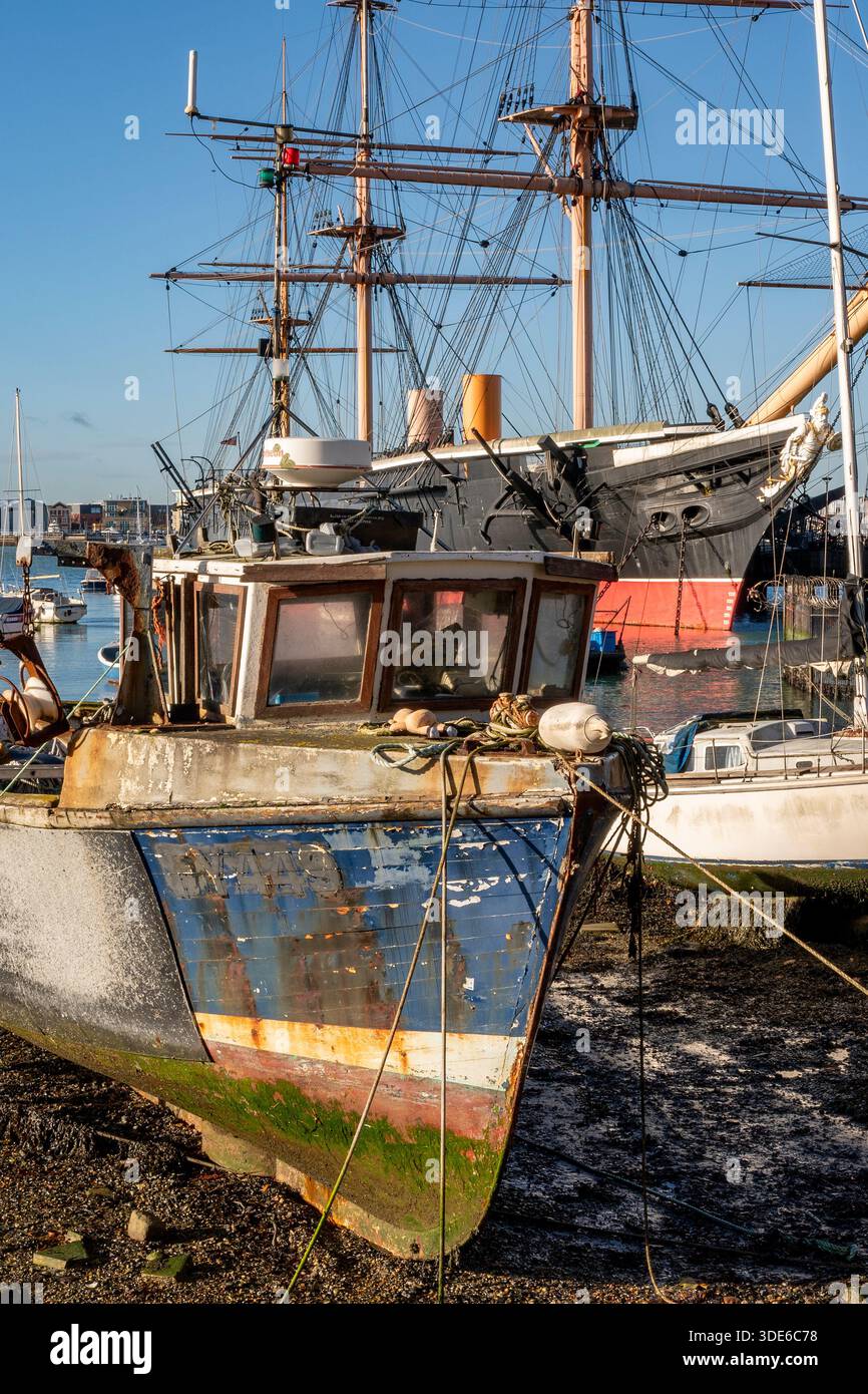 Wreck of an old fishing boat and the historic Naval warship HMS Warrior ...