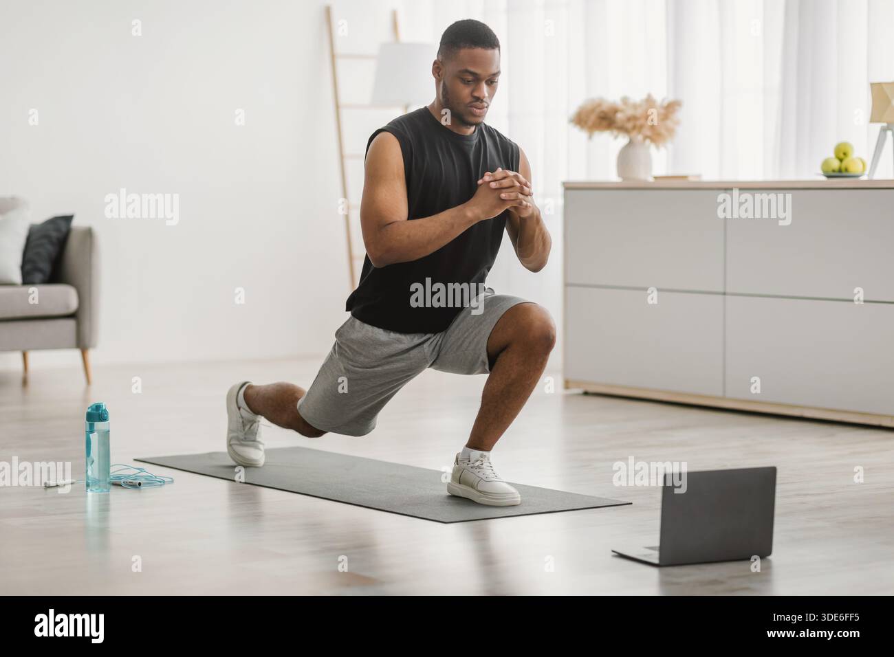 Young man doing forward lunge hi-res stock photography and images - Alamy