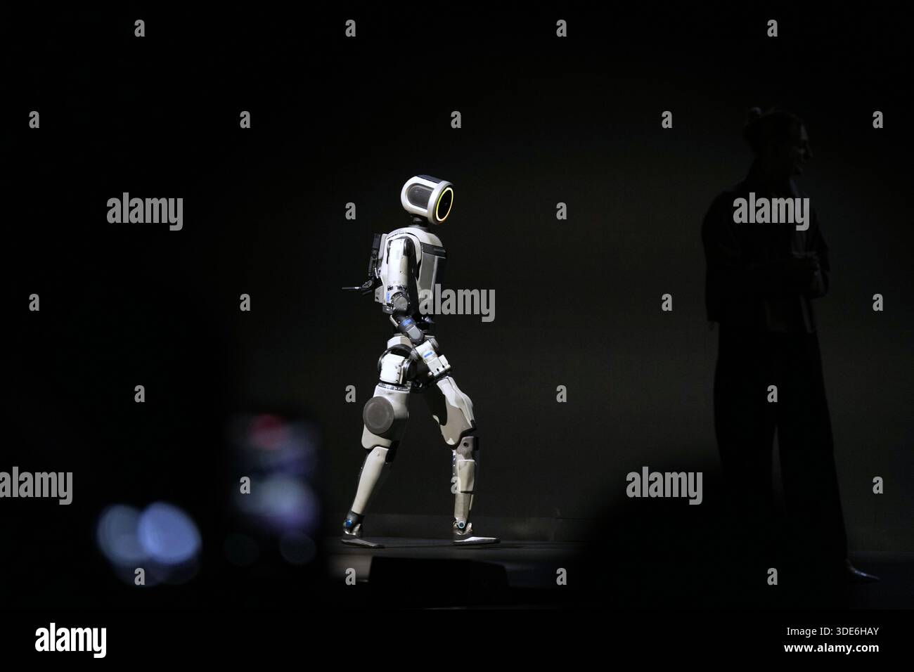 An Atlas robot walks across the stage during a Hyundai and Boston ...