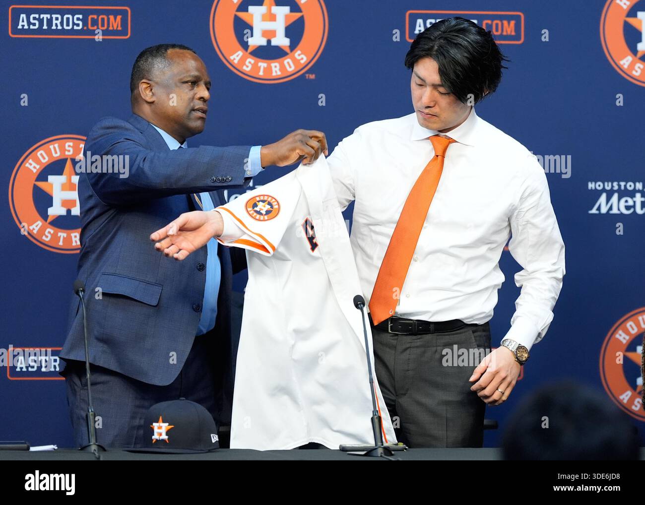 Houston Astros General Manager Dana Brown, left, helps Tatsuya Imai ...