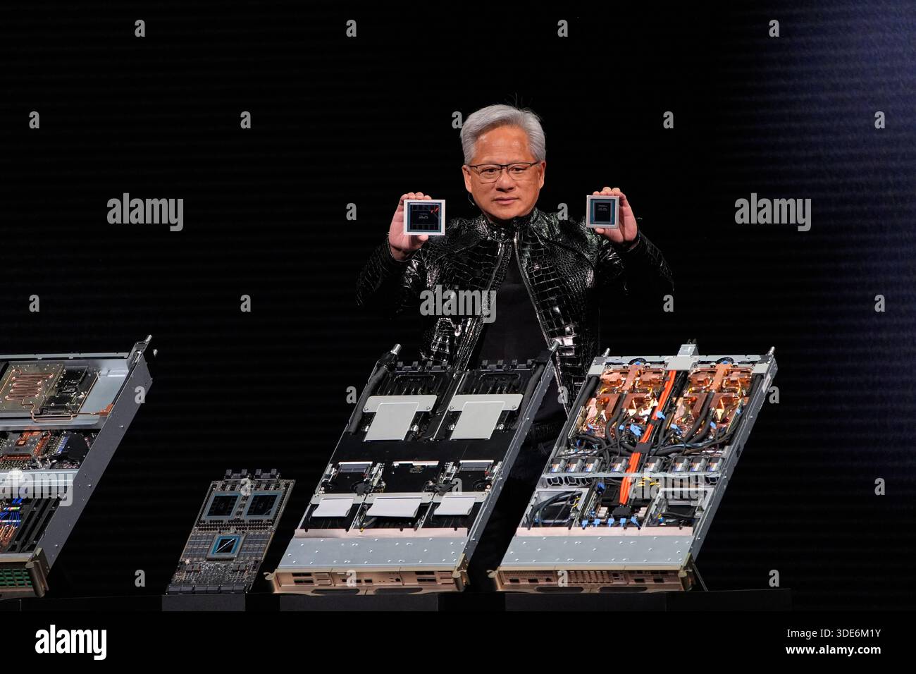 Nvidia founder and CEO Jensen Huang holds up a Rubin GPU and a Vera CPU ...