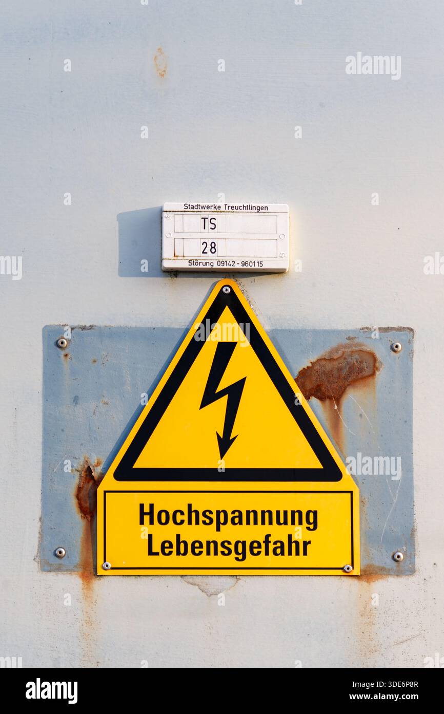 Yellow triangle warning sign with german text indicating danger from ...