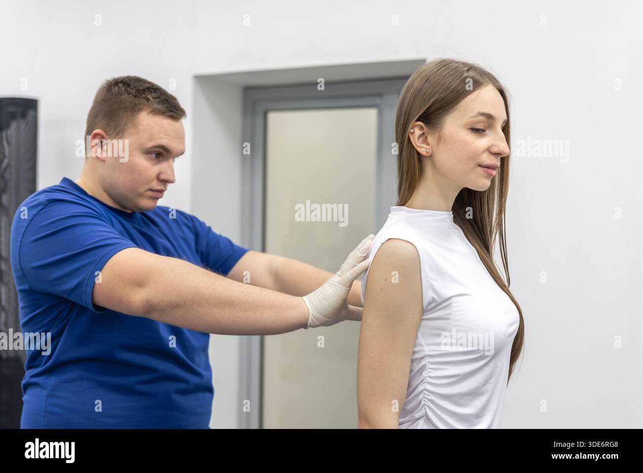 Physiotherapist and female patient get posture correction with back ...