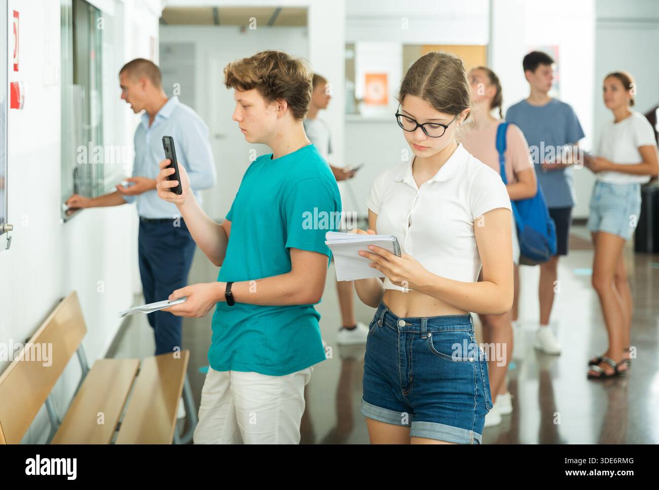 Students record and photograph class schedules in college lobby Stock ...