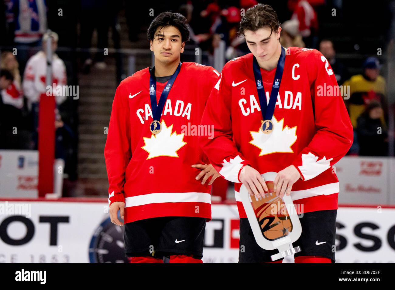 Canada's Zayne Parekh, left, and Porter Martone, right, look on after ...