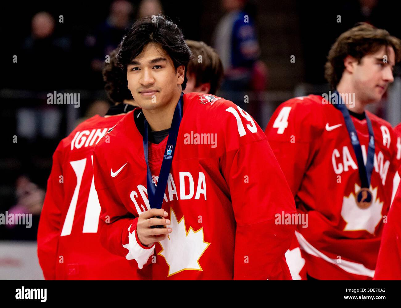 Canada's Zayne Parekh (19) stands with teammates after defeating ...