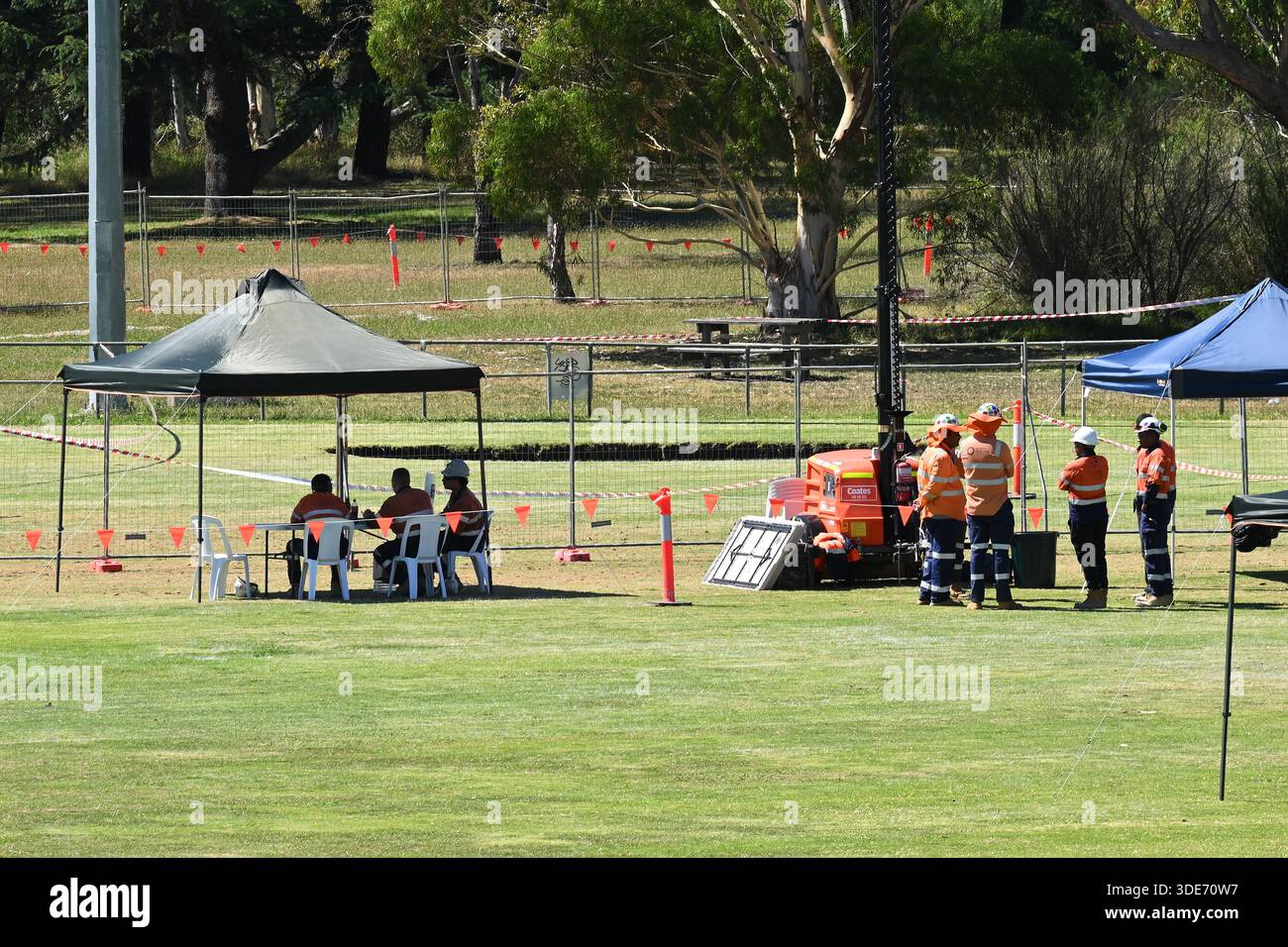 Construction workers are seen at the site where a sinkhole that has ...