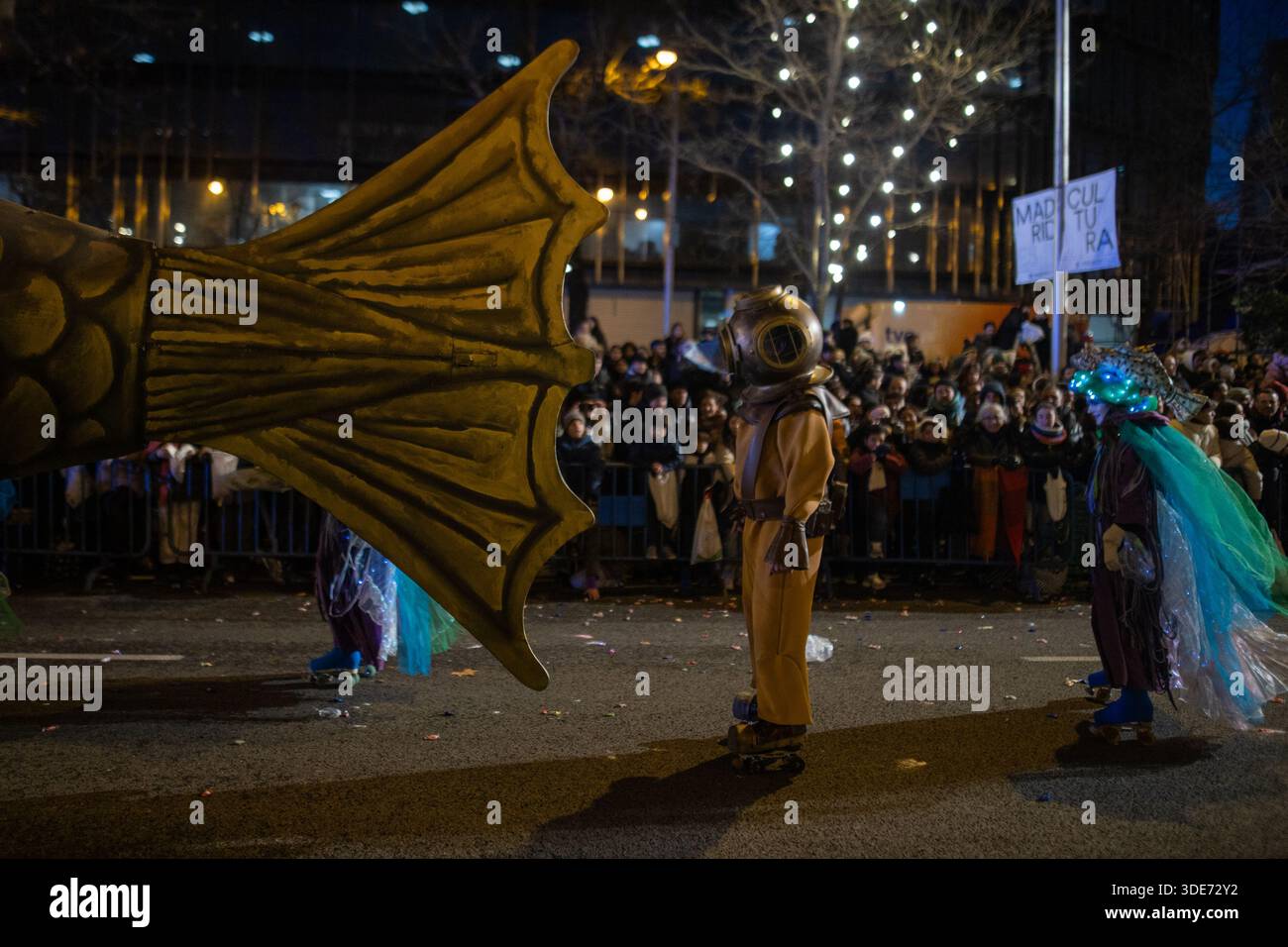 A man in a diving suit parades. during the traditional Three Kings ...