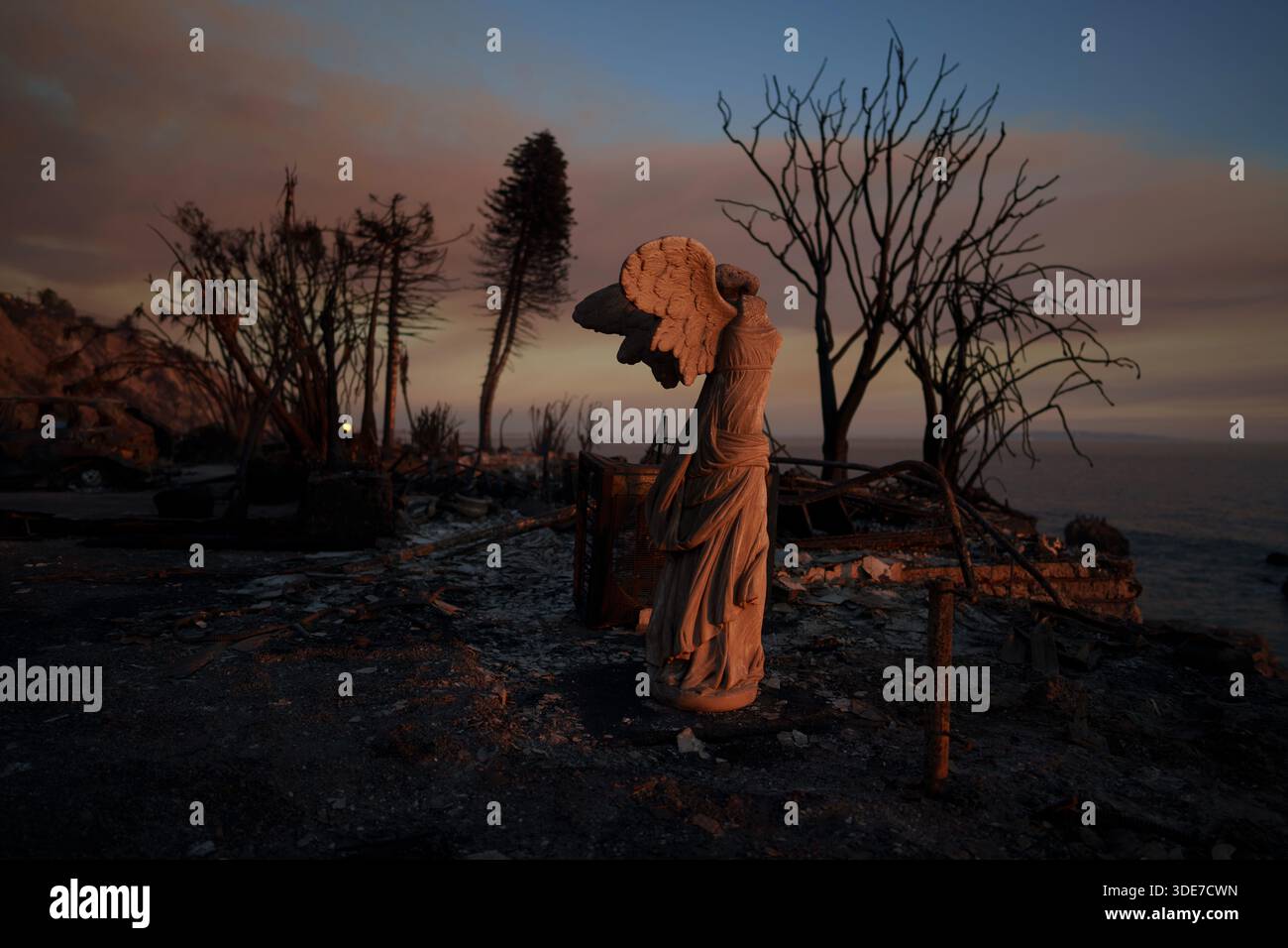 FILE - The sun sets on a fire-ravaged property in the aftermath of the ...