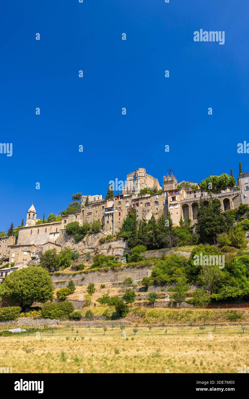Historic French village built into a hillside, featuring ancient stone ...