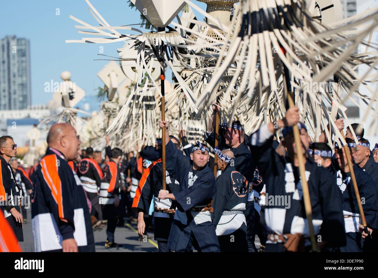 Members of a traditional firefighting preservation group spin a matoi ...