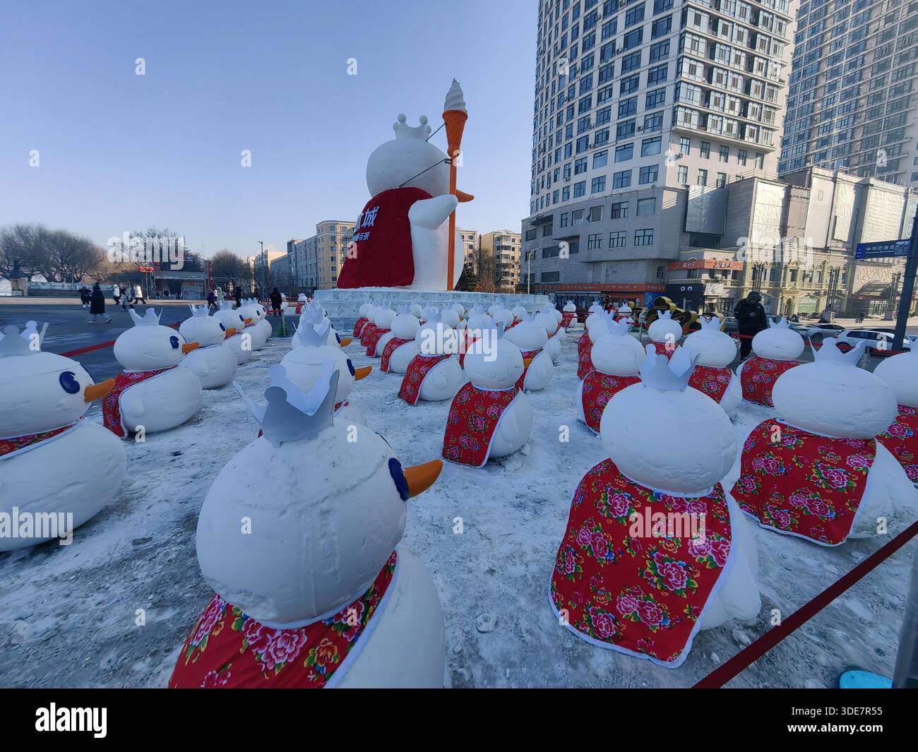 Over 100 small snowmen stand in formation at a riverside square near ...
