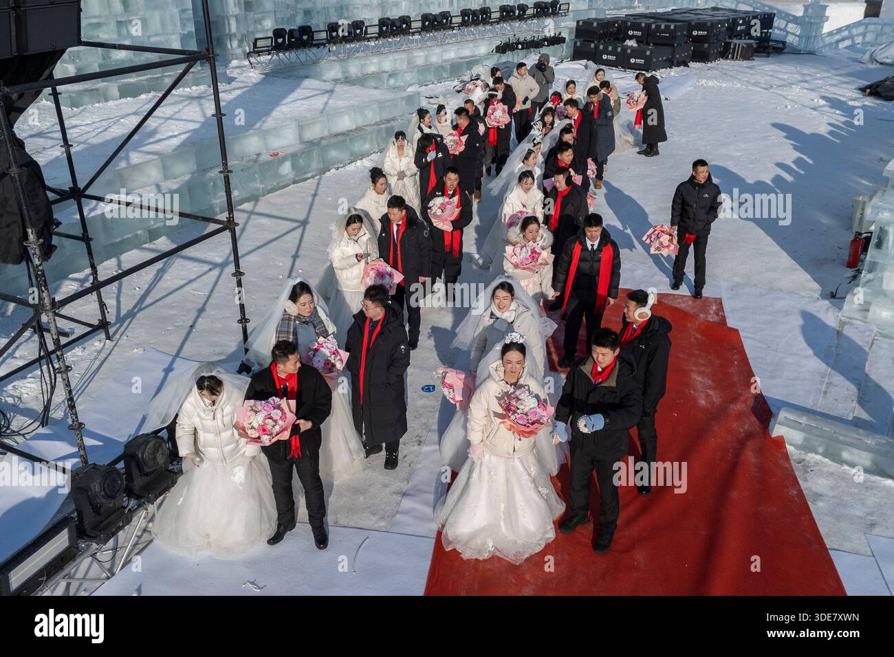 Couples take part in a mass wedding during the annual Ice and Snow ...