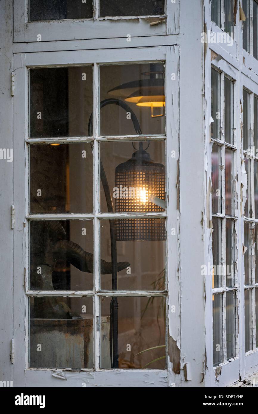 Rotting wooden window frame on period building with lantern and ...