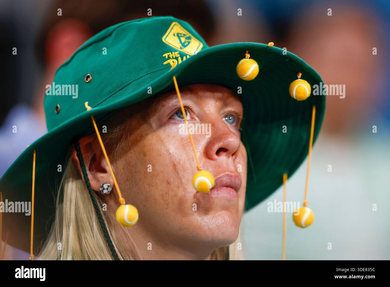 A woman wears an Australian style swagman’s hat with tennis balls ...