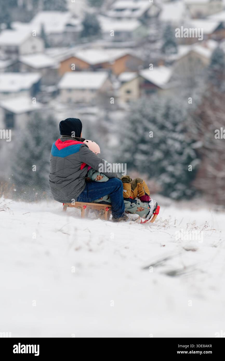06 January 2026, Baden-Württemberg, Wilhelmsfeld: Sledgers ride down a ...