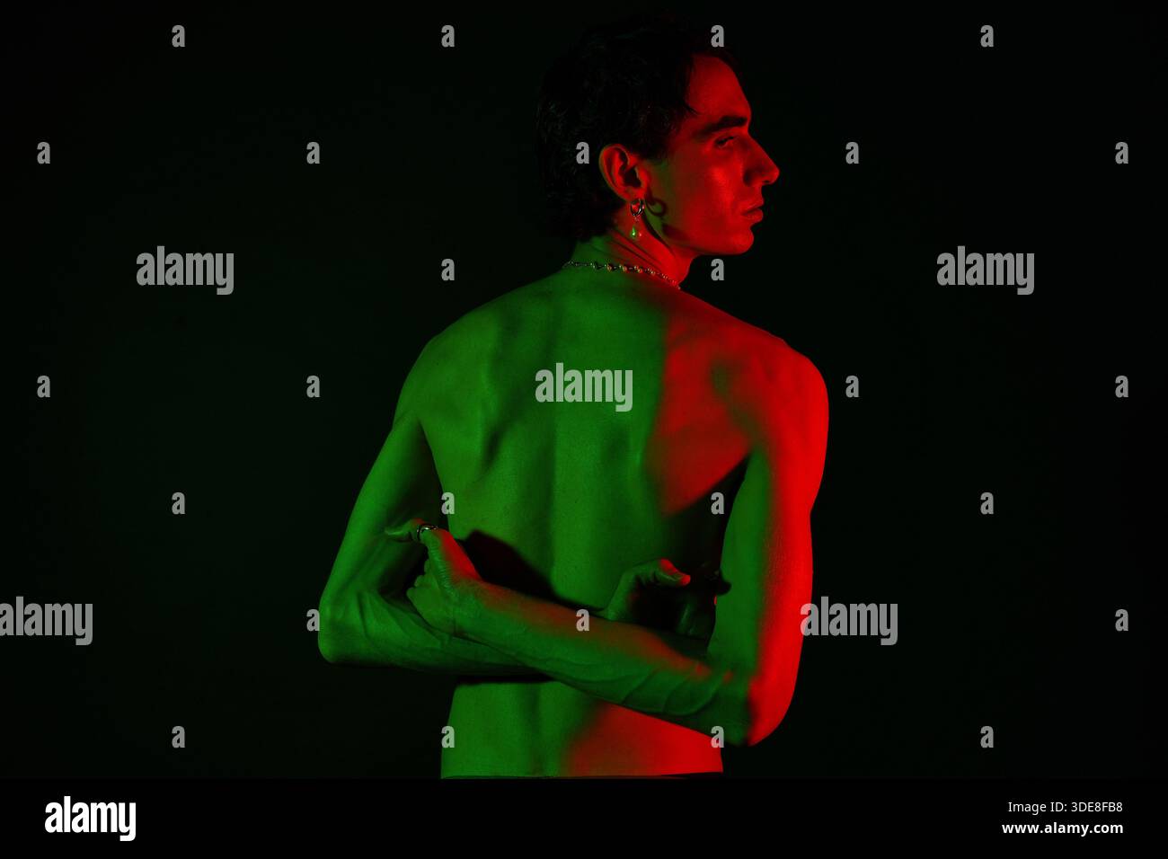 A handsome man poses confidently with an artistic flair, showcasing ...