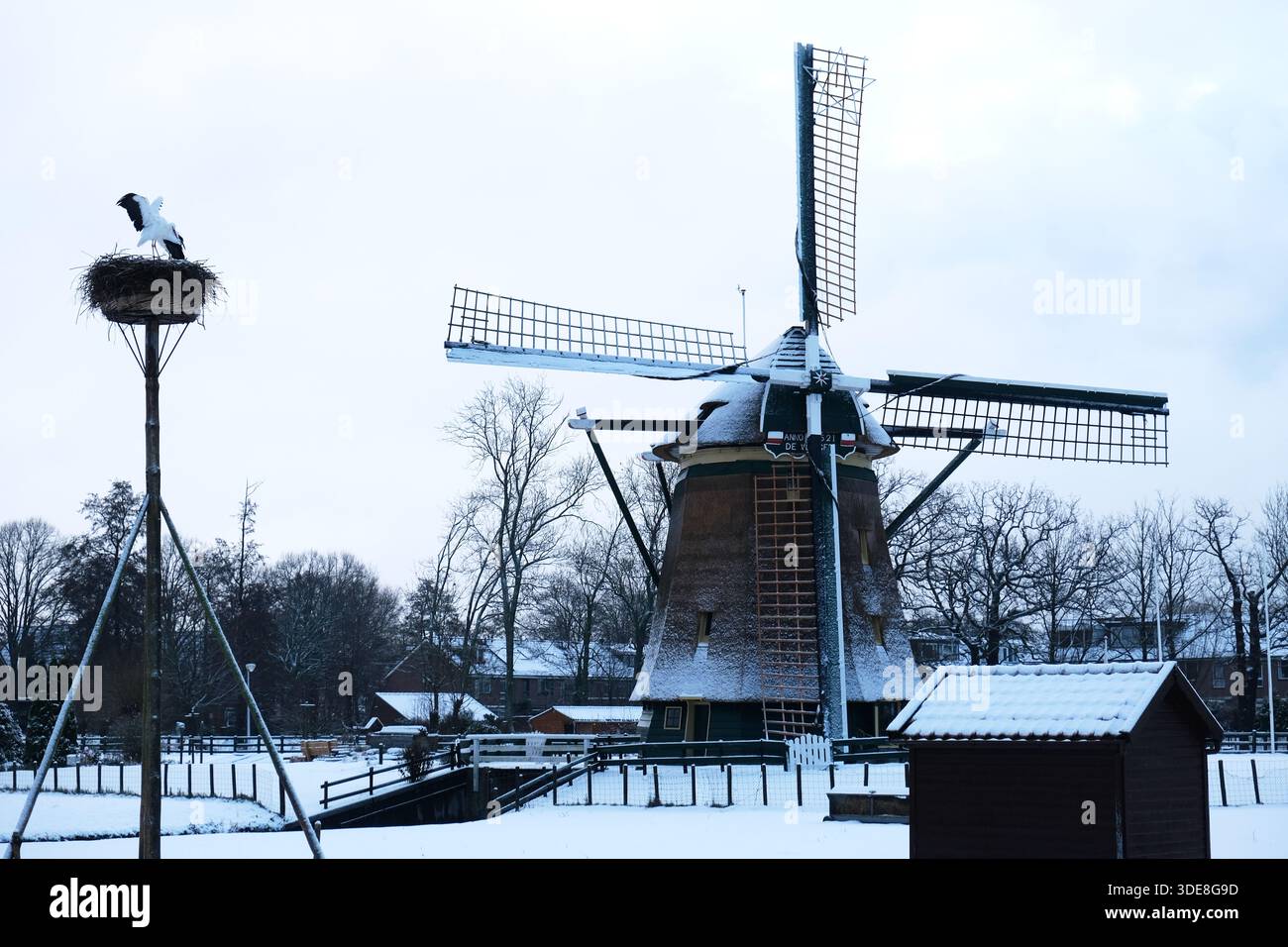 Windmill De Vlieger stands in a snowy field in the town of Voorburg on ...