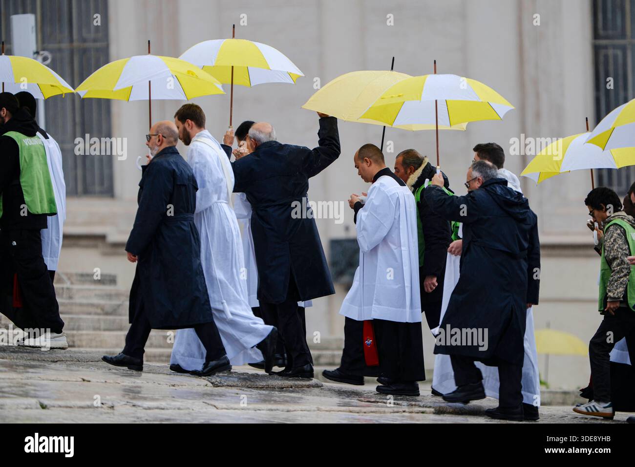 Members of the clergy enter St. Peters Basilica, accompanied by Vatican ...