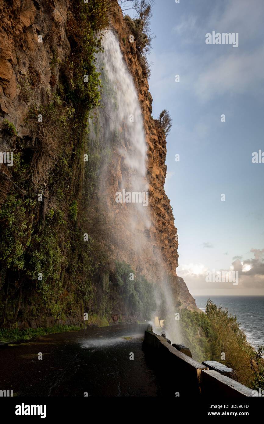 Vertical view of water from Cascata dos Anjos waterfall spilling over a ...