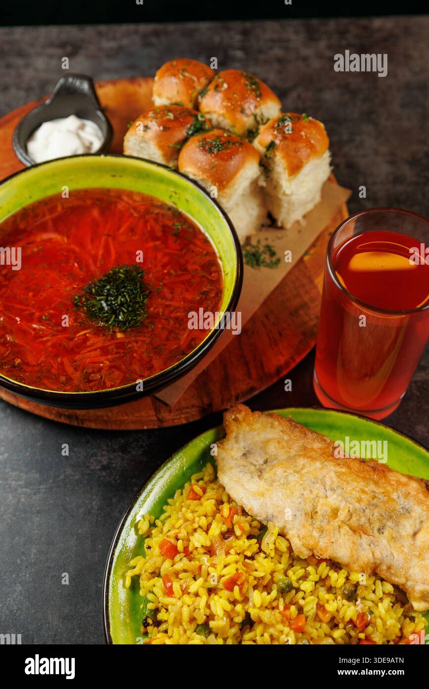A bountiful spread showcases Ukrainian borscht with bread rolls, fried ...