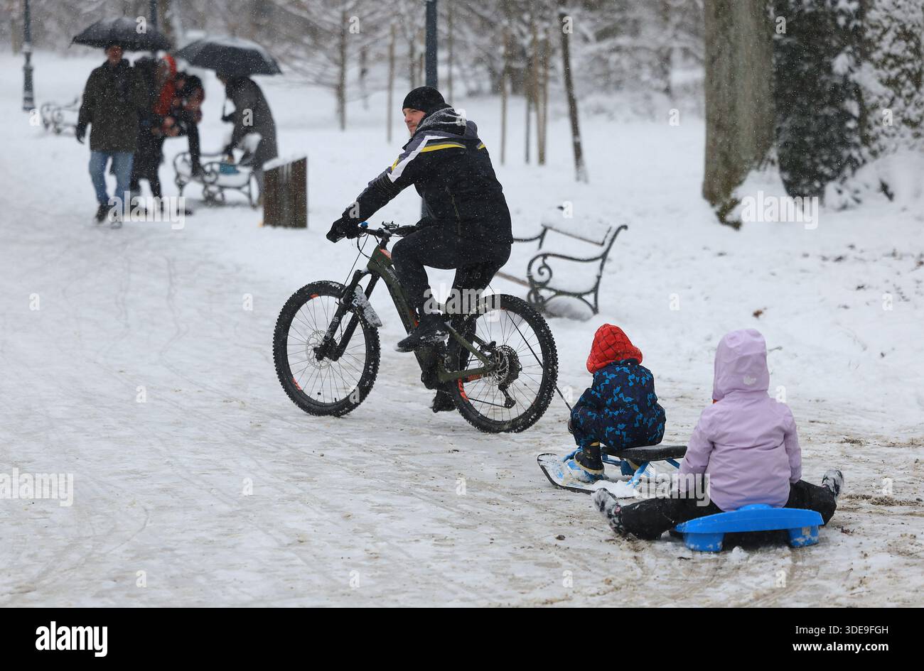 People ride on a sledge in a snow-covered Maksimir park in Zagreb ...