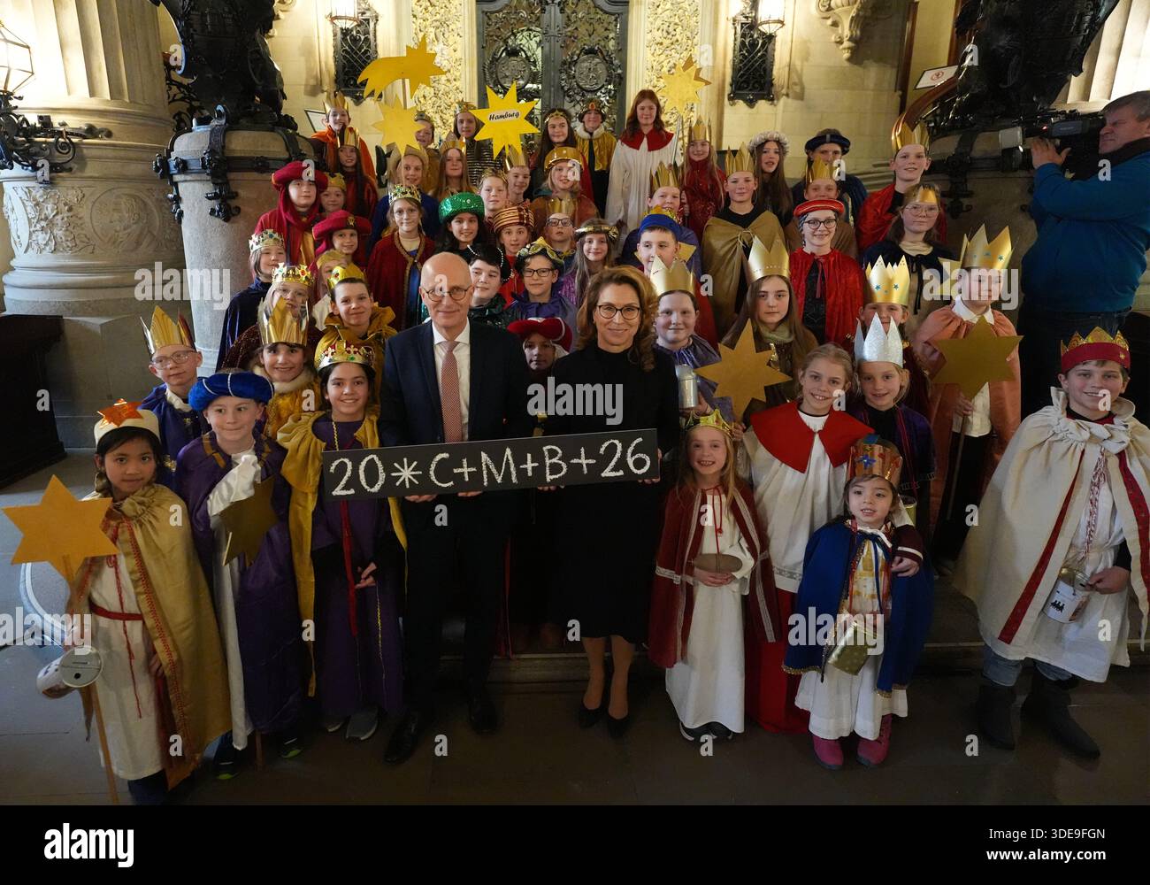 06 January 2026, Hamburg: Catholic carol singers stand together with ...