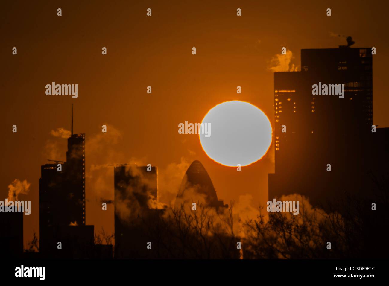London, UK. 6 Jan 2026. The sky glows orange as the Sun rises in cold ...