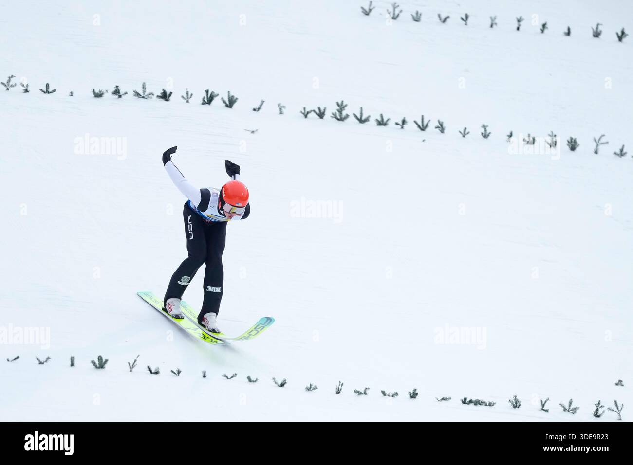 Jason Colby, of the United States, lands his trial jump at the fourth ...