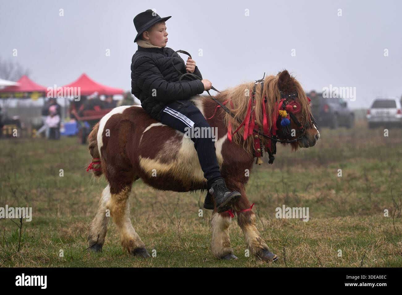 A boy rides a pony during Epiphany celebrations in Pietrosani, Romania ...