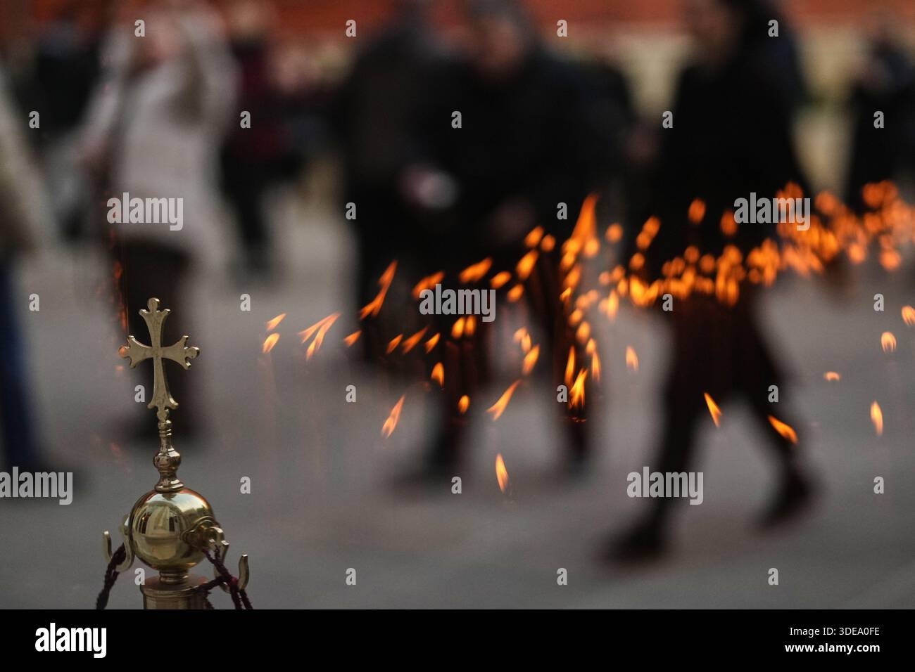 Lights candles are reflected in a glass as Orthodox Christian faithfuls ...