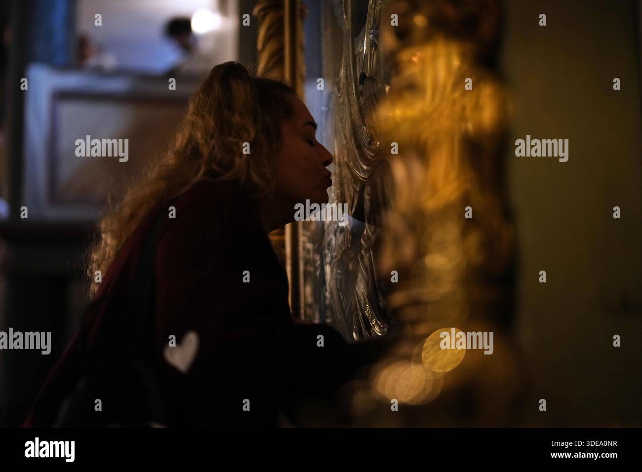 A Orthodox Christian faithful kisses an icon during the Epiphany ...