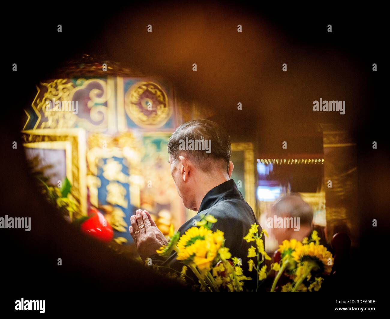 29 November 2024, Taiwan, Taipeh: A Buddhist woman stands with folded ...