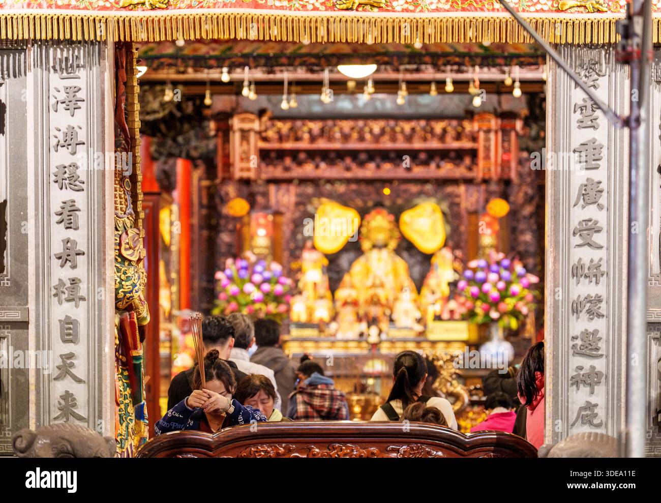 29 November 2024, Taiwan, Taipeh: A Buddhist woman stands with folded ...